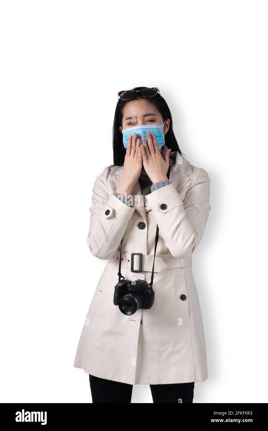 Young beautiful Asian women sling a camera and wearing a medical face ...