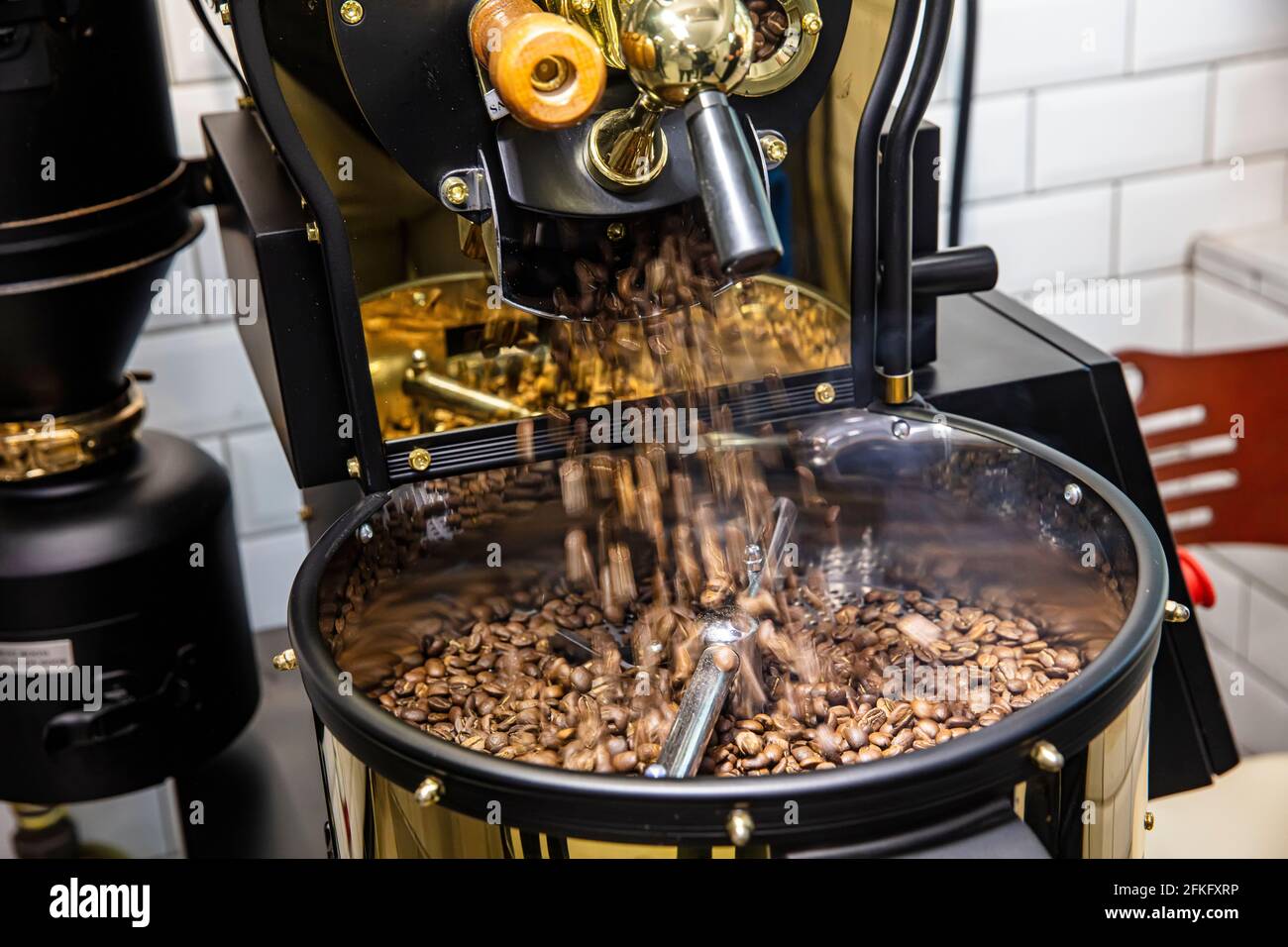 Coffee Roaster. Roasting coffee beans hand close up. Top view near ...
