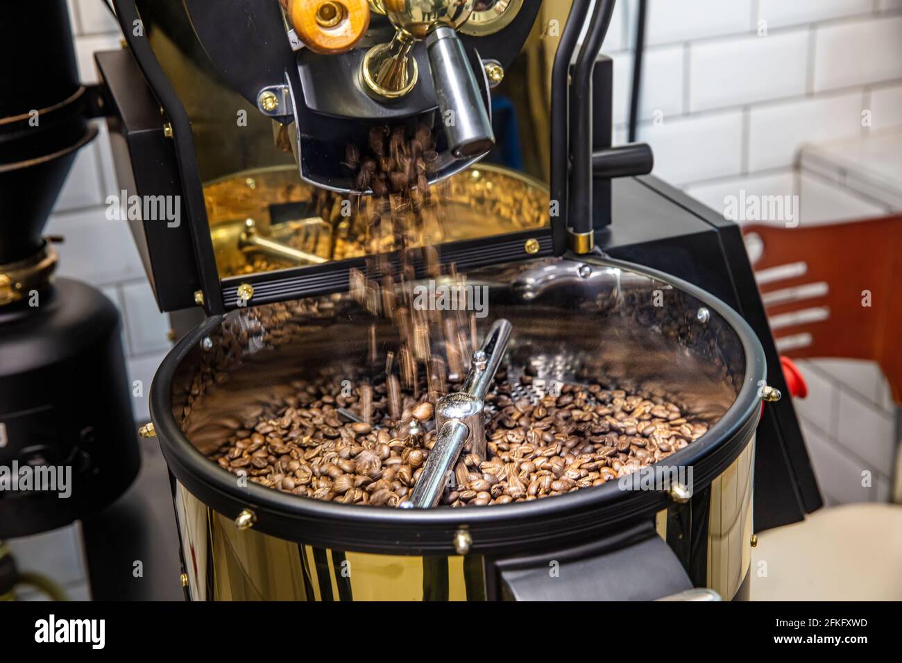 Coffee Roaster. Roasting coffee beans hand close up. Top view near ...
