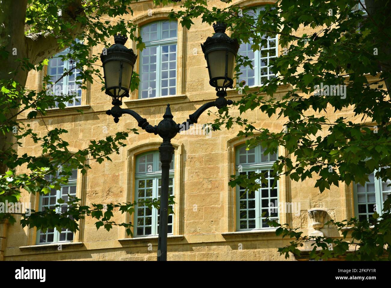 Baroque style building facade with stone walls and symmetrical arched ...