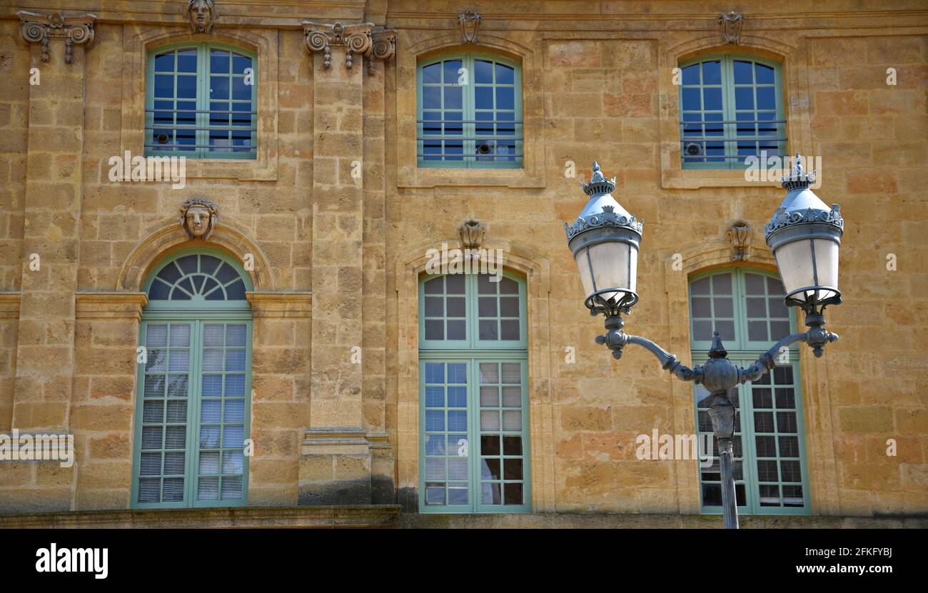 Baroque style building facade with stone walls and symmetrical arched ...