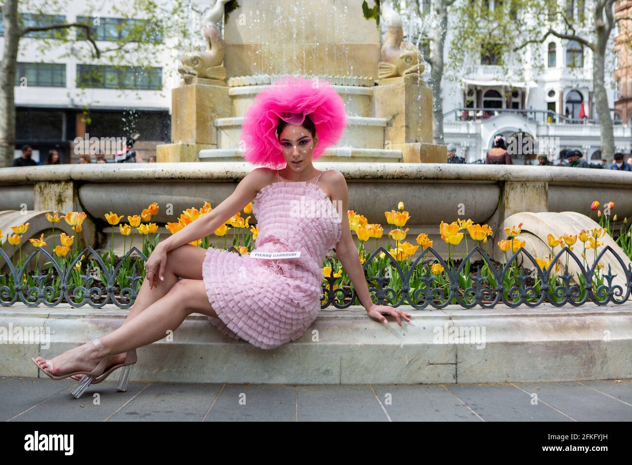 A model showcases Pierre Garroudi's latest colourful collection at one ...