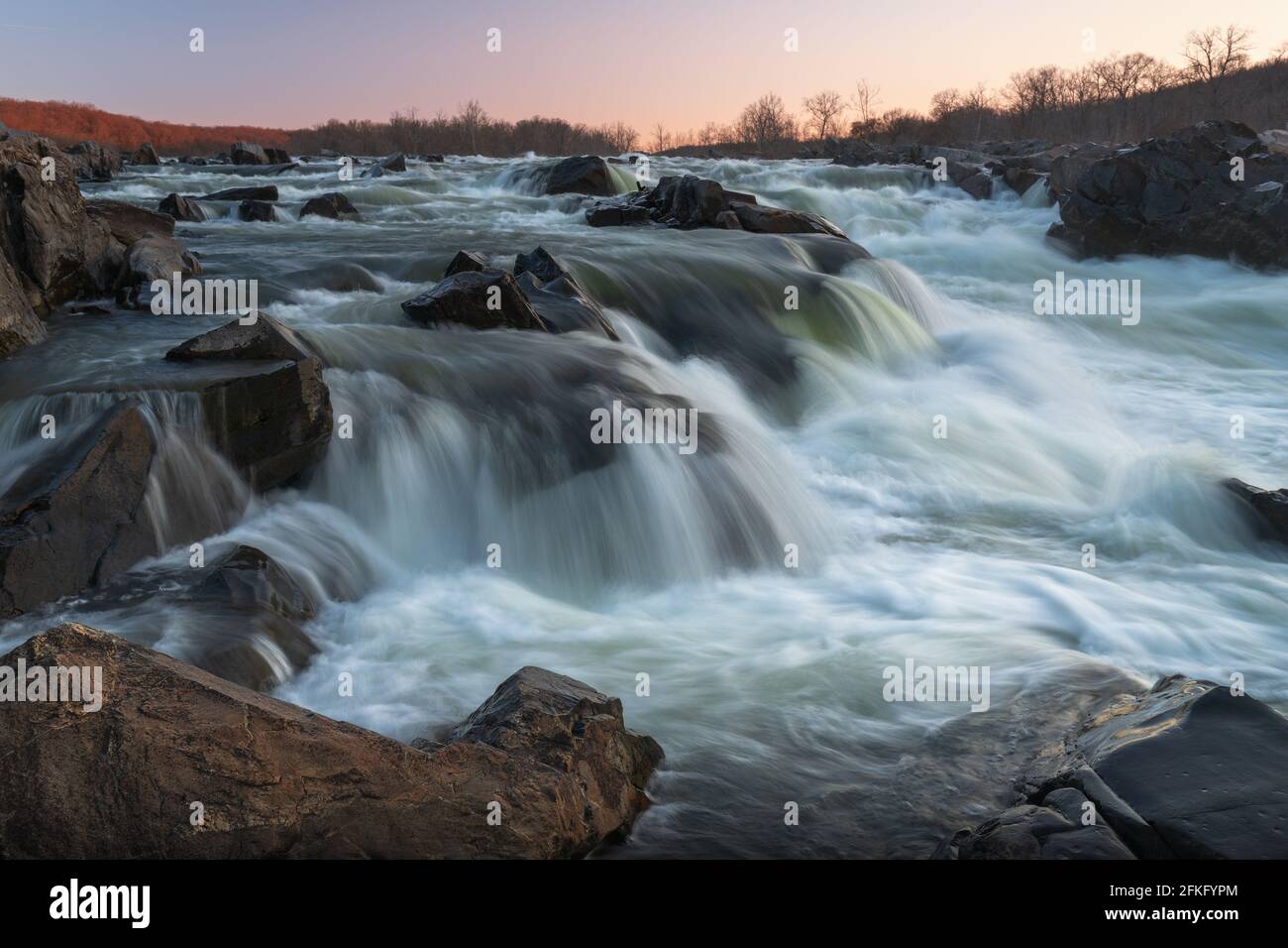 Early morning waterfall and rapids of the Potomac River with purple ...