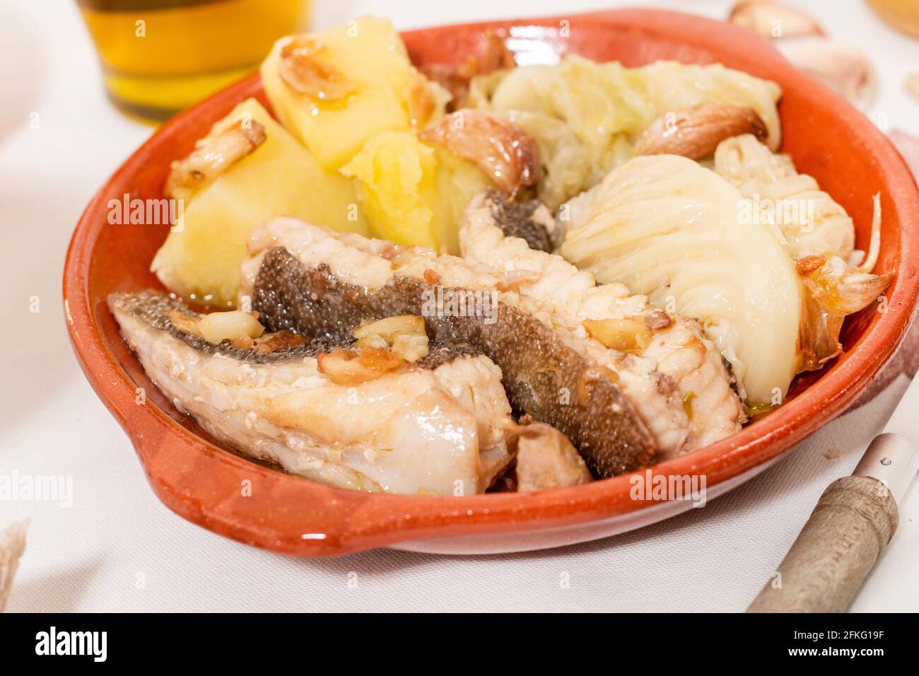 Typical portuguese homemade ray fish with potatos and garlic and olive ...