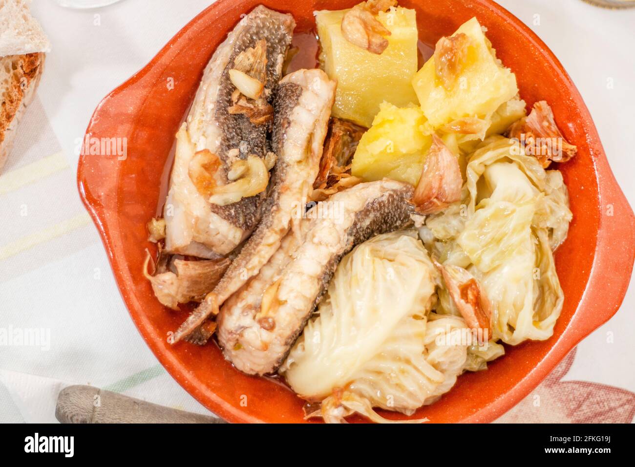Typical portuguese homemade ray fish with potatos and garlic and olive ...