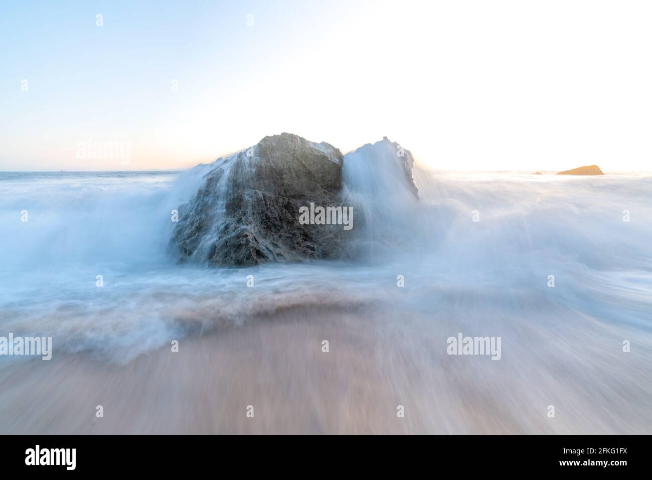 Beautiful shot of sea waves with smooth effect breaking on coastal rock ...