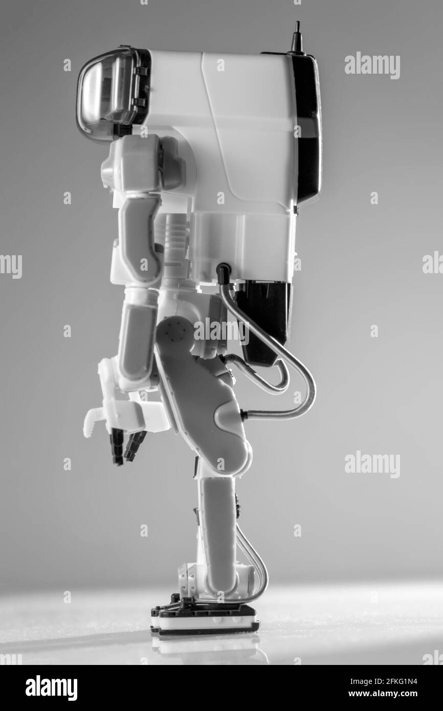 Modern advanced autonomous robot toy isolated on a gray background ...