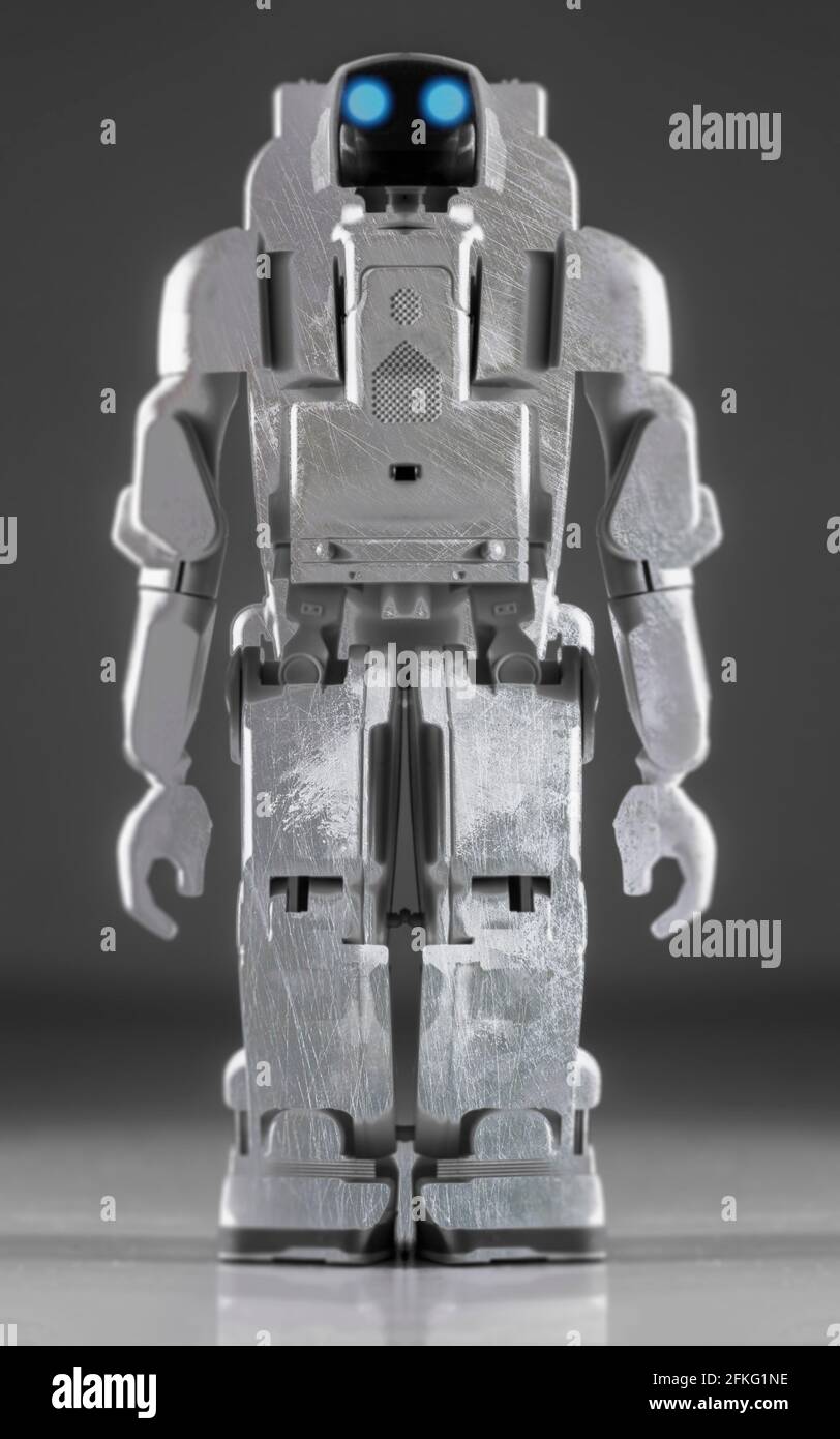 Modern advanced autonomous robot toy isolated on a gray background ...