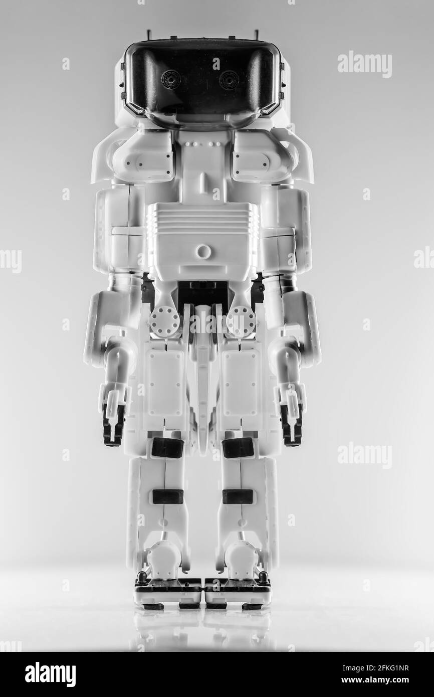 Modern advanced autonomous robot toy isolated on a gray background ...