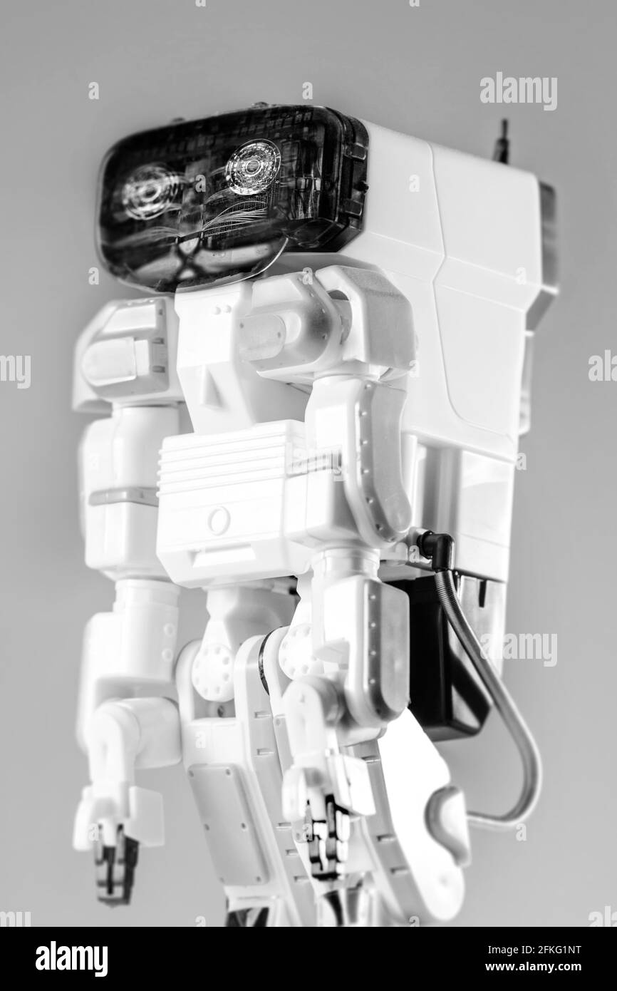 Modern advanced autonomous robot toy isolated on a gray background ...