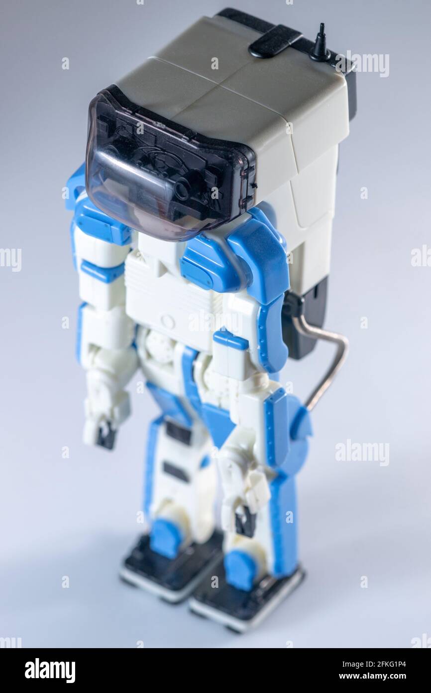 Modern advanced autonomous robot toy isolated on a gray background ...