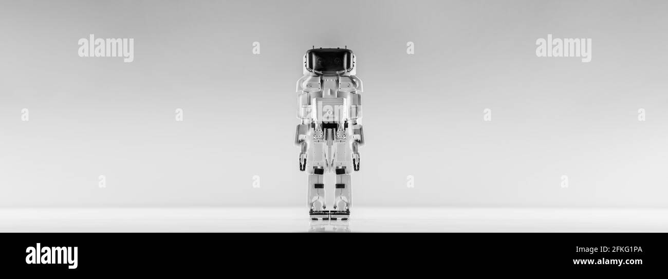 Modern advanced autonomous robot toy isolated on a gray background ...