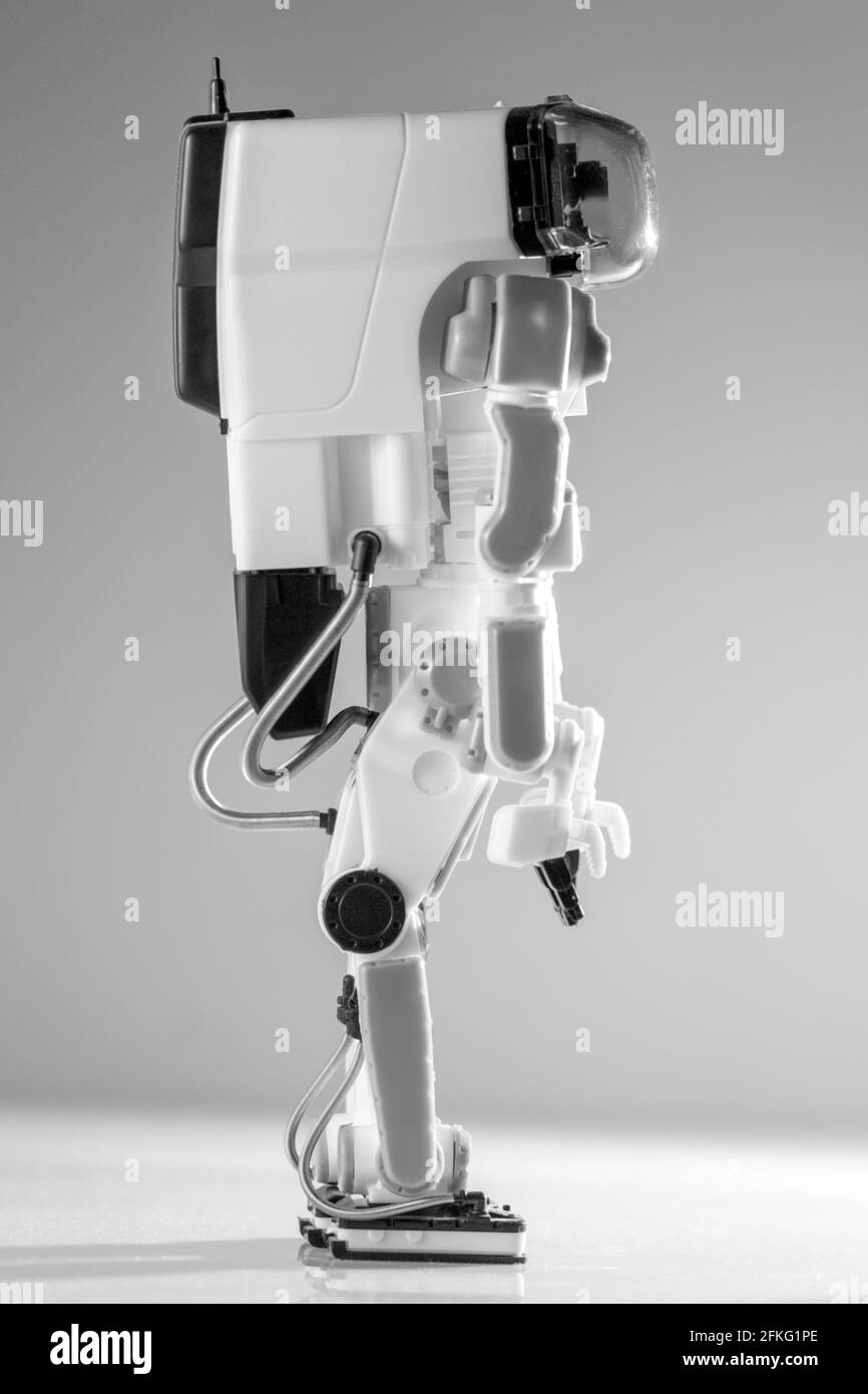 Modern advanced autonomous robot toy isolated on a gray background ...