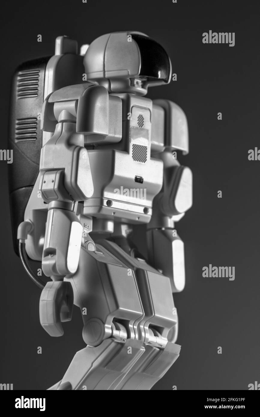 Modern advanced autonomous robot toy isolated on a gray background ...