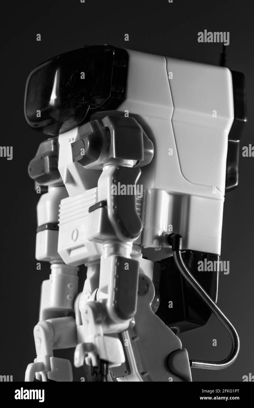 Modern advanced autonomous robot toy isolated on a gray background ...