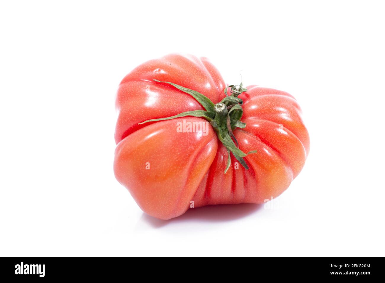 Beef heart tomato isolated on a white background Stock Photo - Alamy