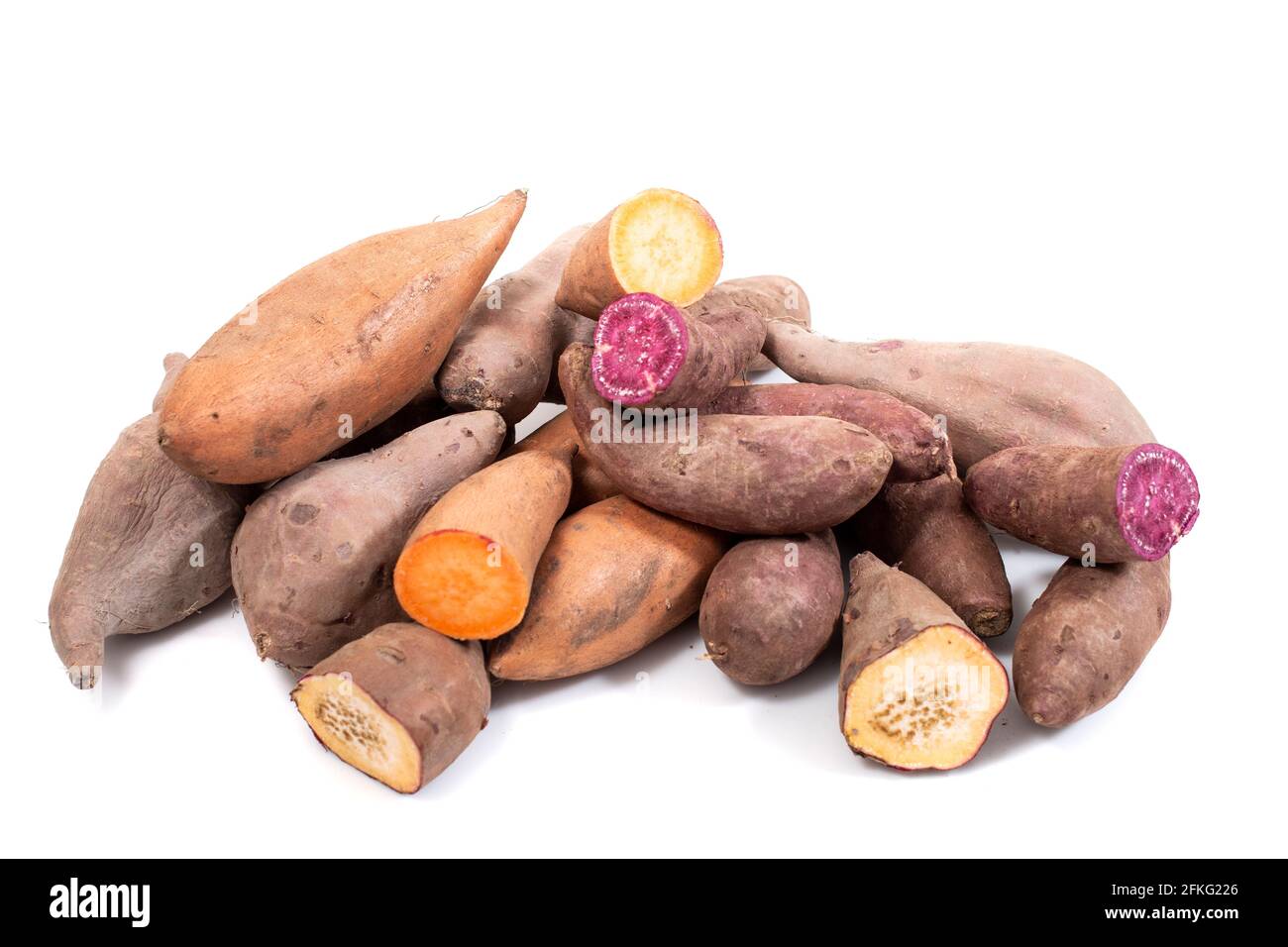 Mixed varieties sweet potatos root vegetables isolated on a white ...