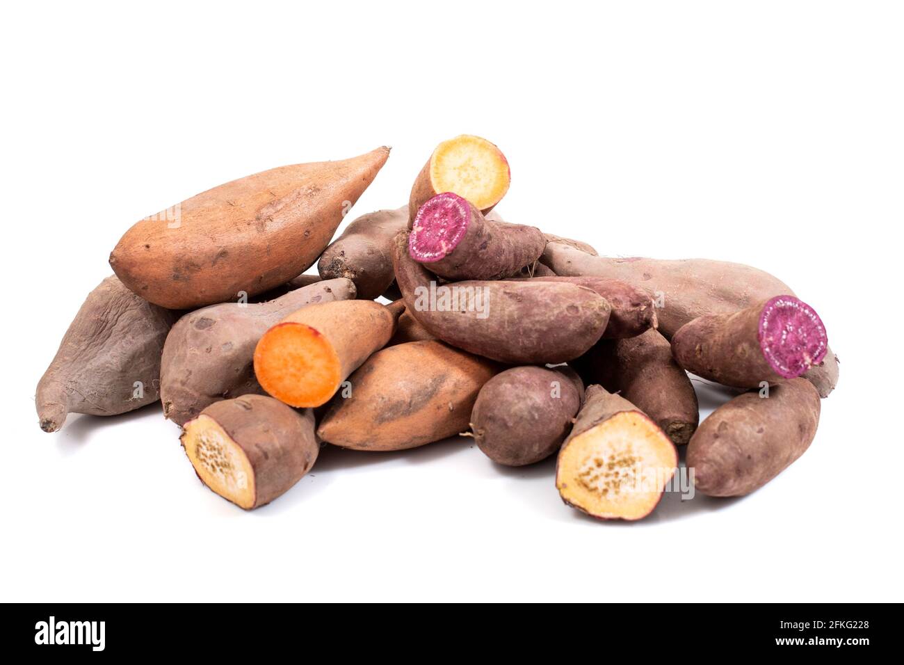 Mixed varieties sweet potatos root vegetables isolated on a white ...