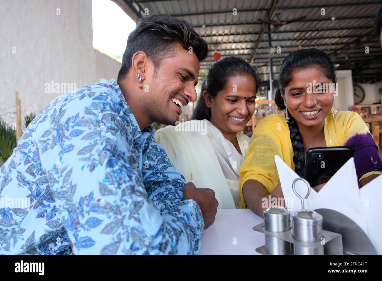 Group of happy young Indian friends having fun in a cafe Stock Photo ...
