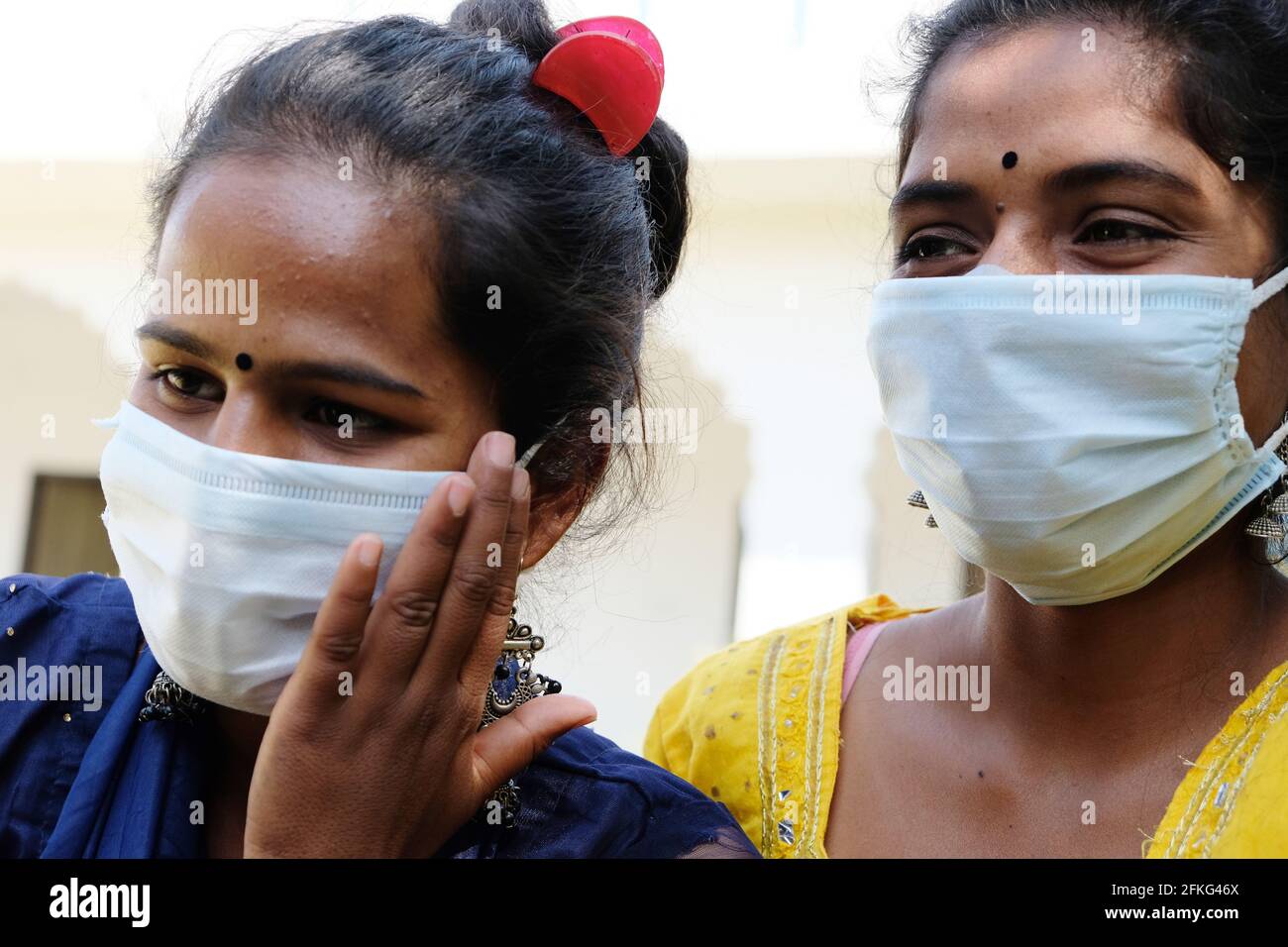 Young Indian female friends wearing medical face masks outdoors Stock ...