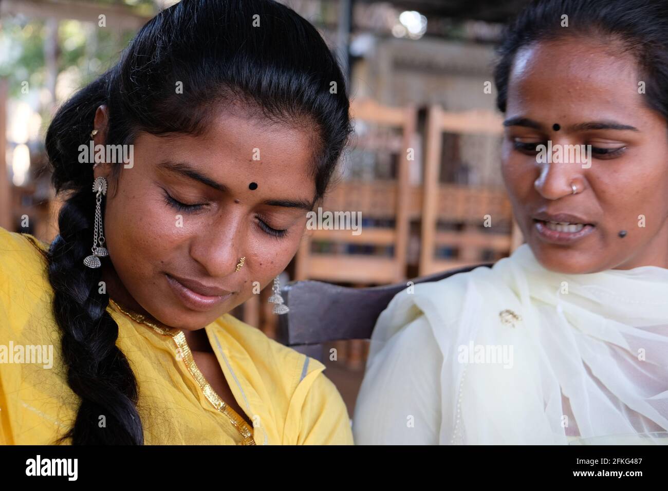 Portrait of two young Indian female friends enjoying their time in a ...