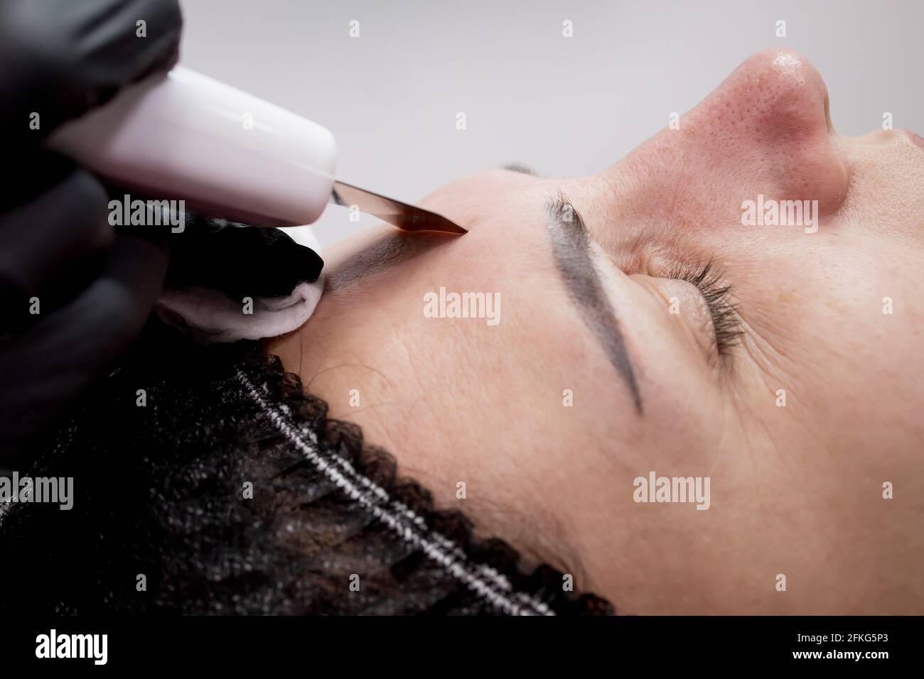 Cosmetologist,beautician making facial treatment with ultrasonic ...
