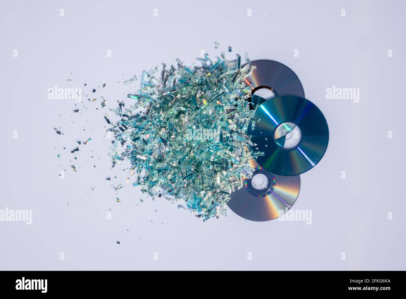 DVDs and CDs partially destroyed with shredder into small parts Stock ...