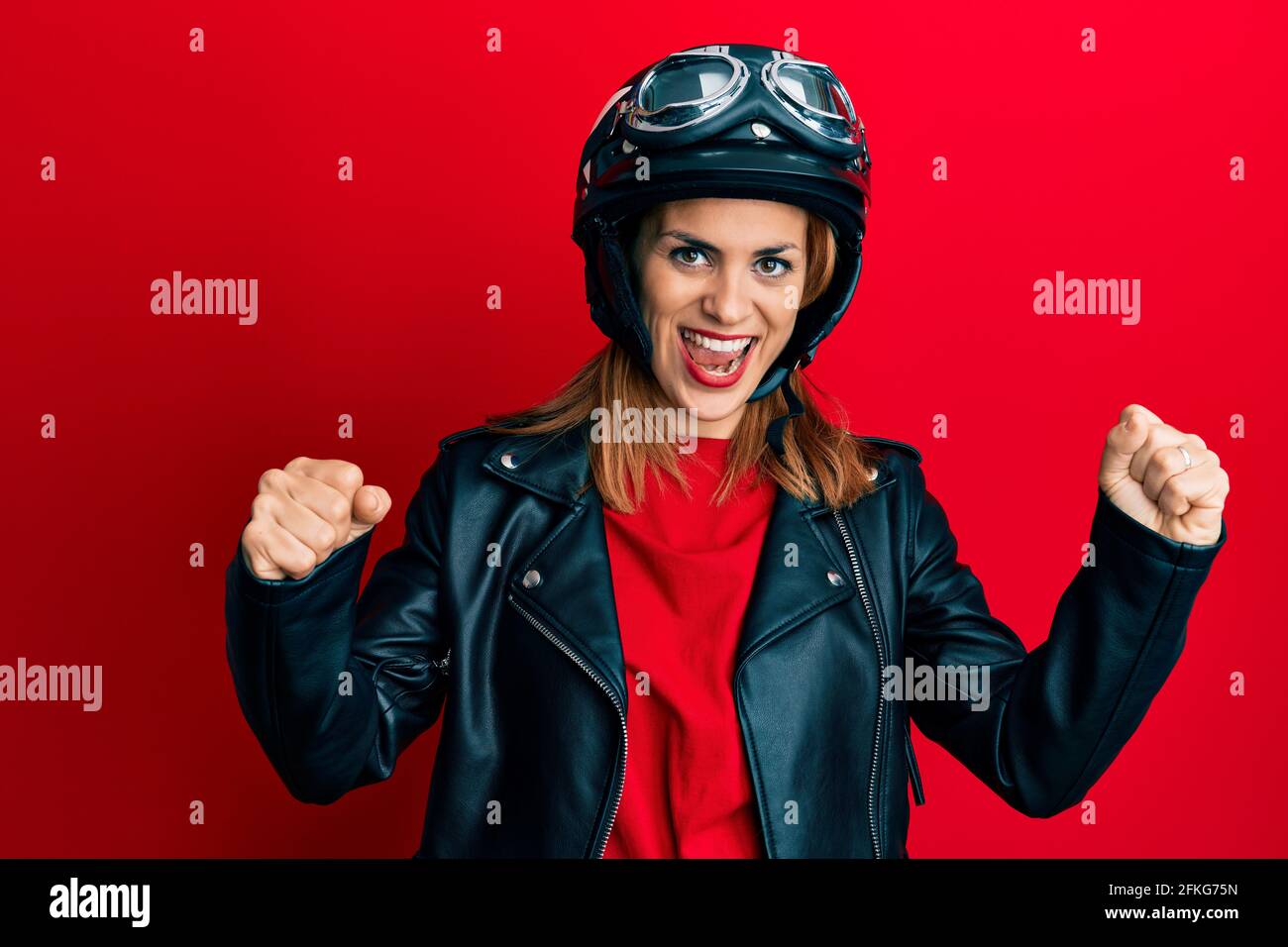 Hispanic young woman wearing motorcycle helmet screaming proud ...