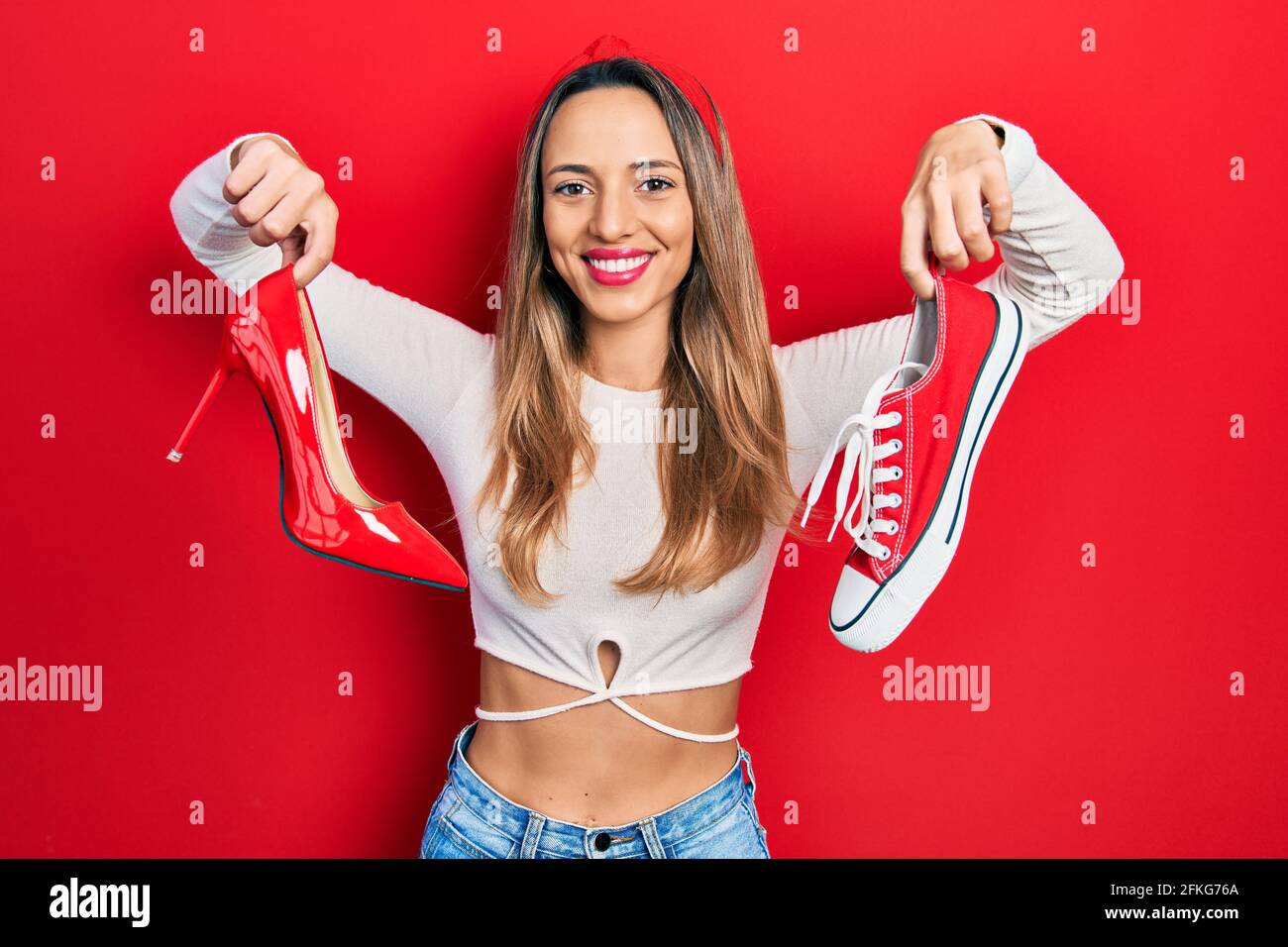 Beautiful hispanic woman choosing high heel shoes and sneakers smiling ...
