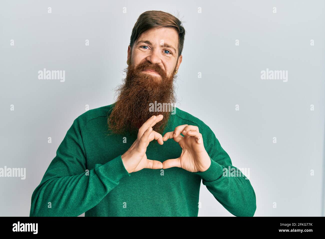 Redhead man with long beard wearing casual clothes smiling in love ...