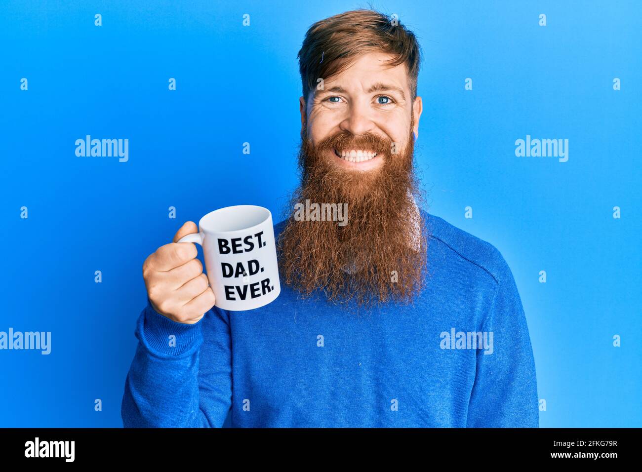 Young irish redhead man drinking mug of coffe with best dad ever ...