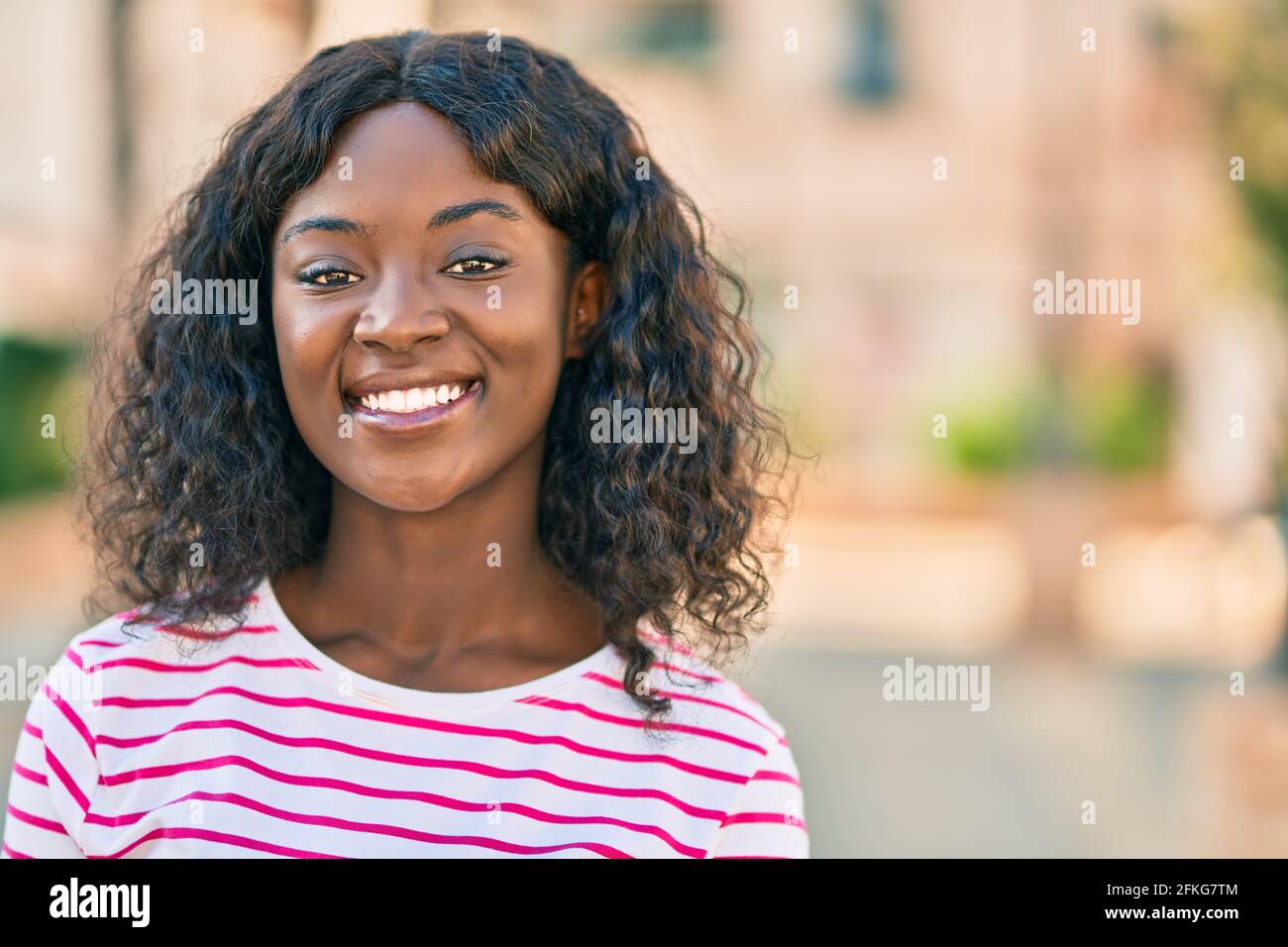 Young african american girl smiling happy standing at the city Stock ...