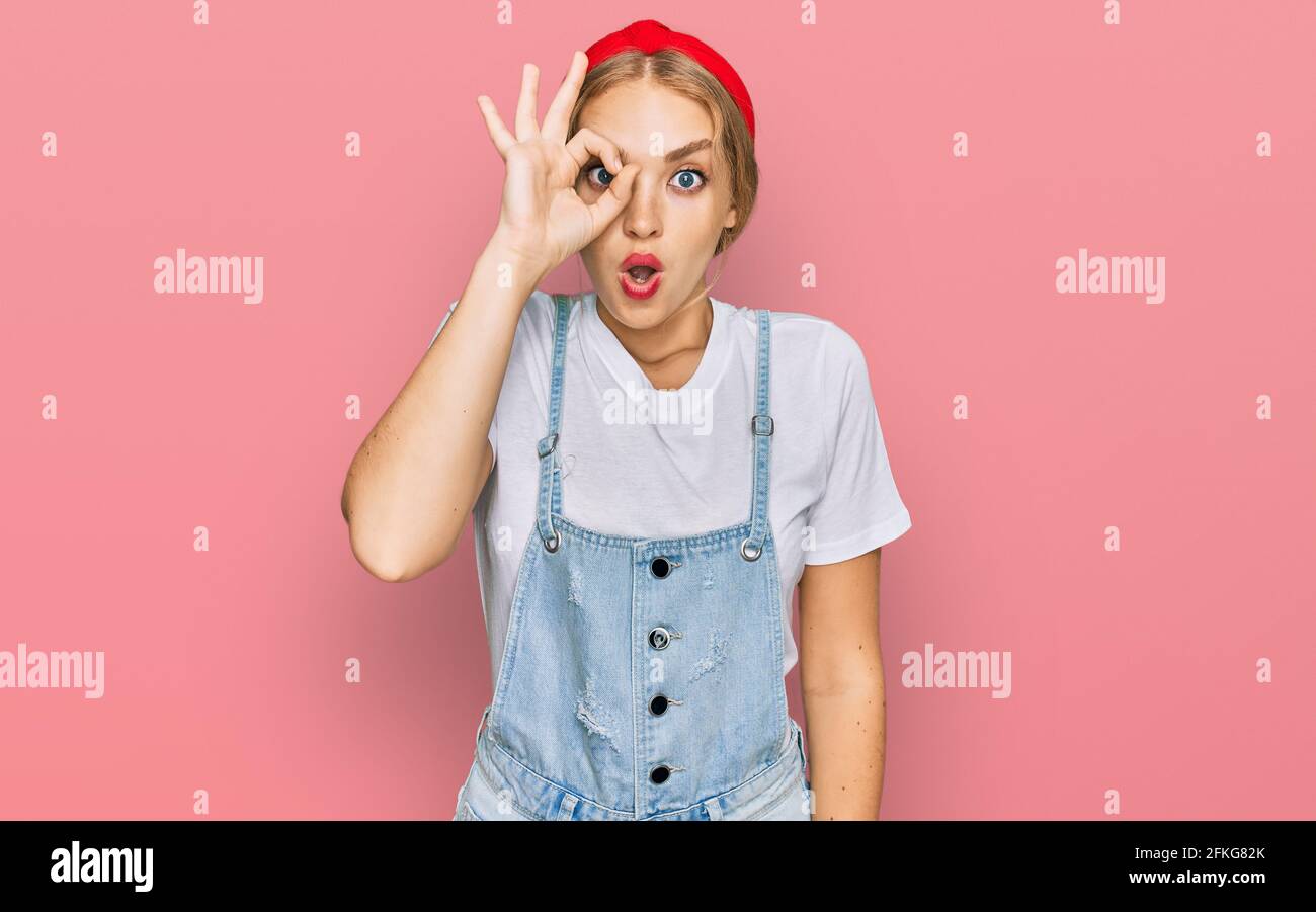 Young caucasian girl wearing casual clothes doing ok gesture shocked ...