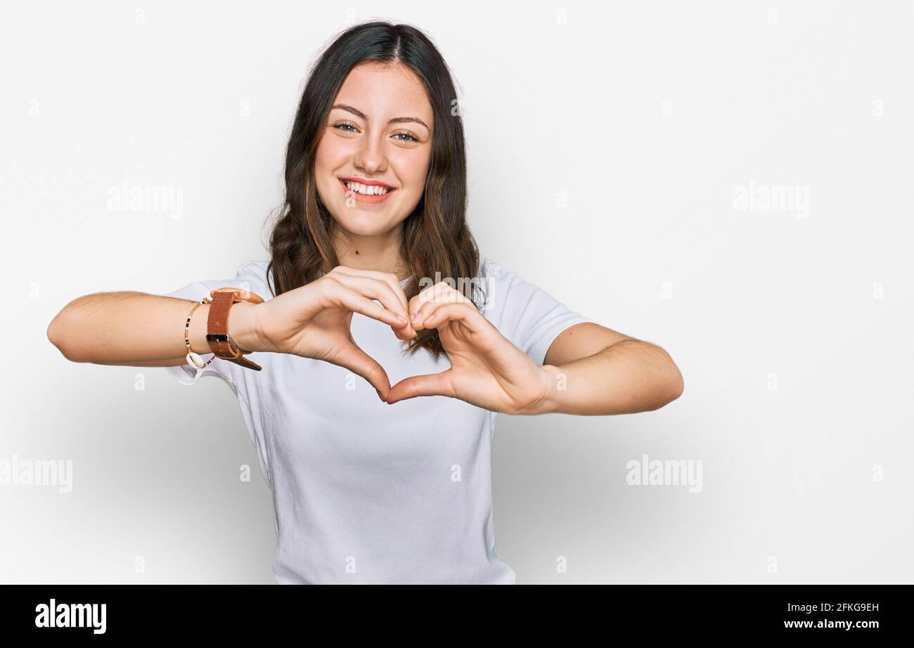 Young beautiful woman wearing casual white t shirt smiling in love ...