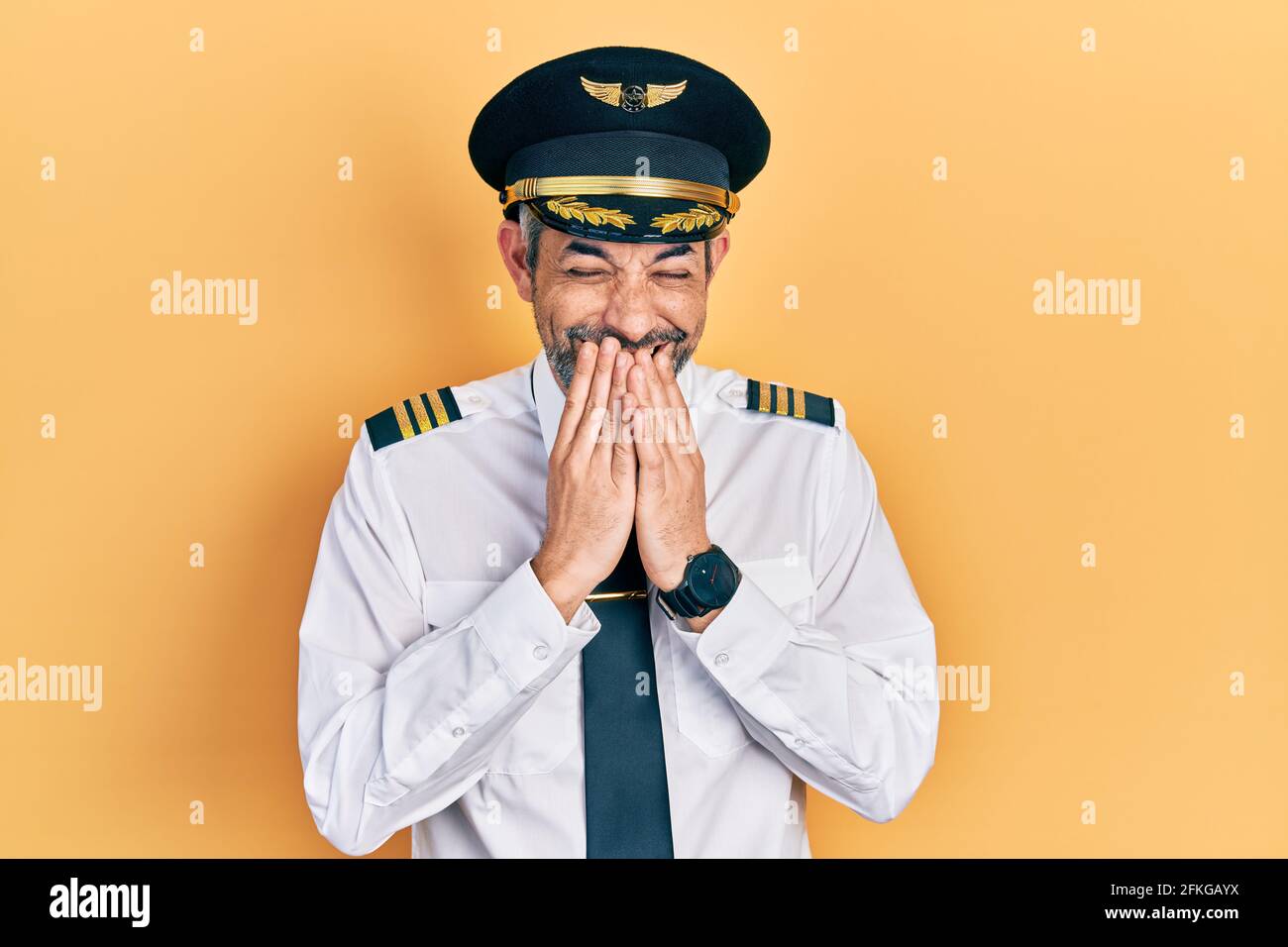 Handsome middle age man with grey hair wearing airplane pilot uniform ...