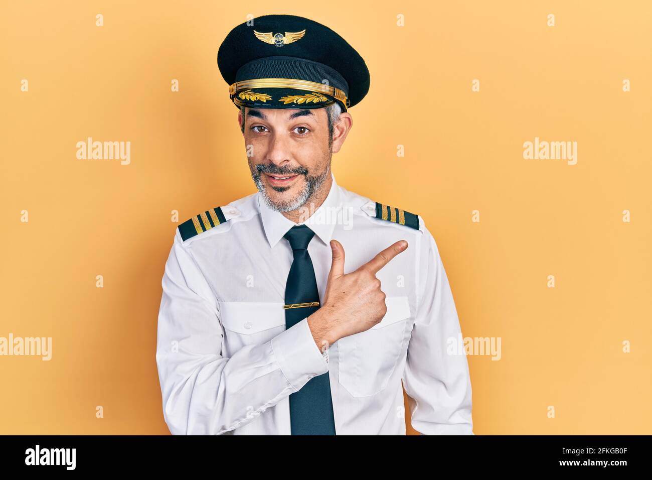 Handsome middle age man with grey hair wearing airplane pilot uniform ...
