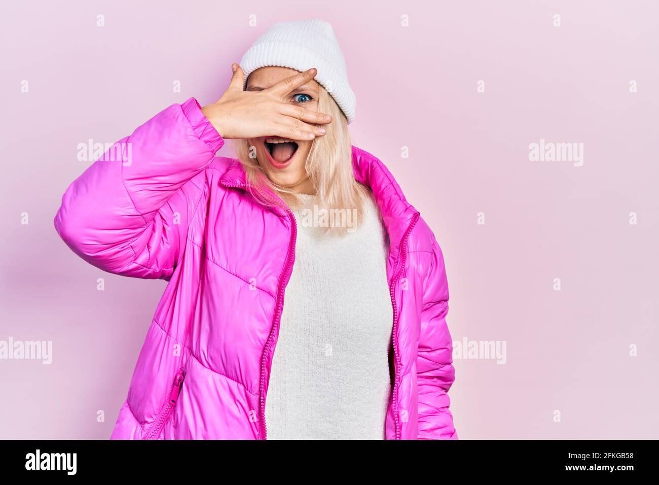 Beautiful caucasian blonde woman wearing wool hat and winter coat ...