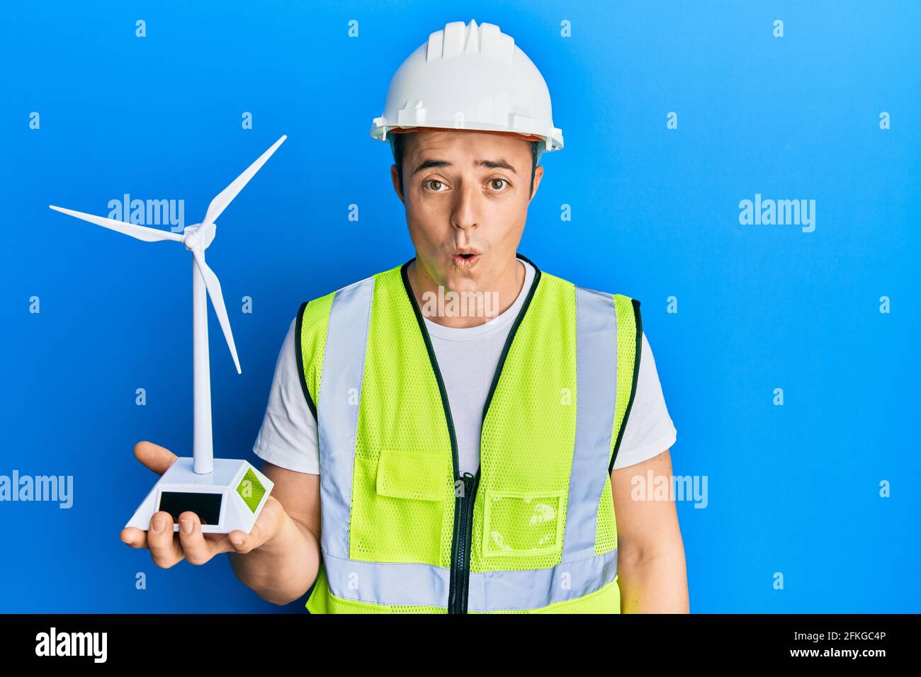 Handsome young man holding solar windmill for renewable electricity ...