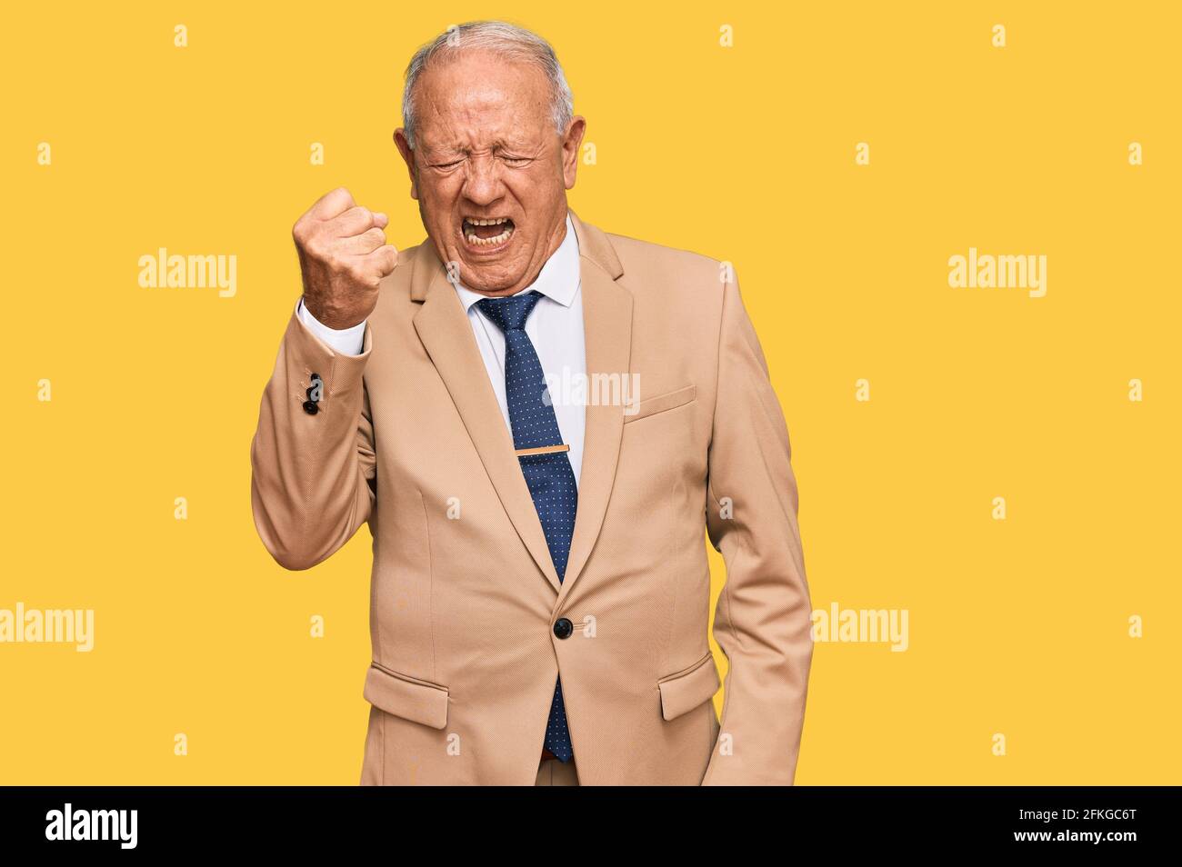 Senior caucasian man wearing business suit and tie angry and mad ...