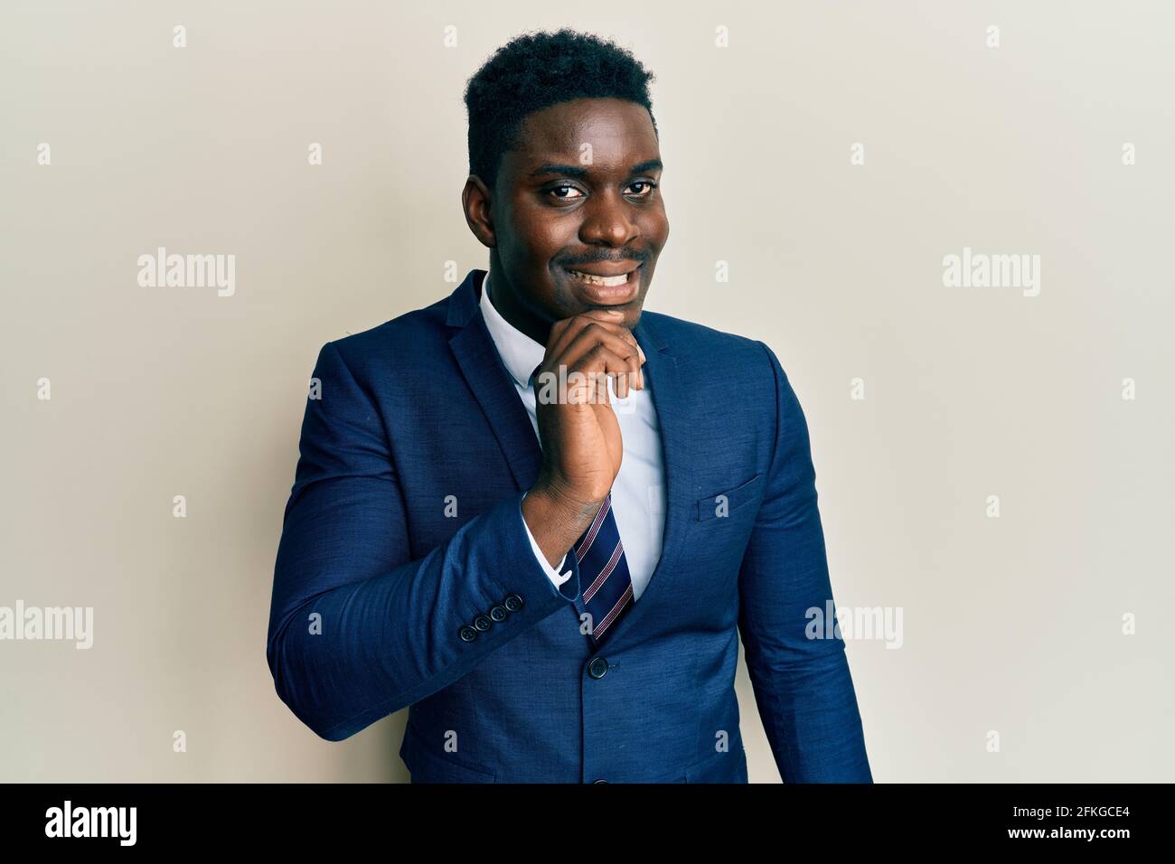 Handsome black man wearing business suit and tie smiling looking ...