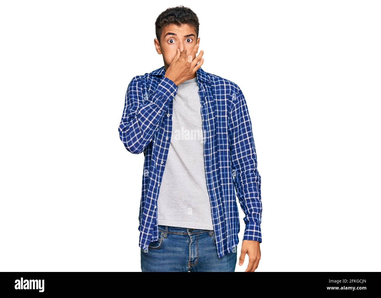 Young handsome african american man wearing casual clothes smelling ...