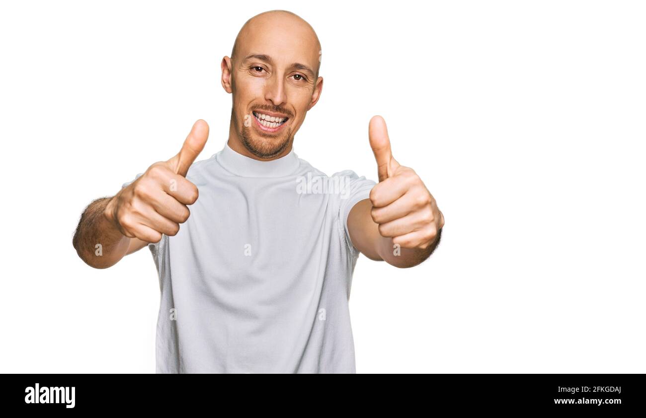 Bald man with beard wearing casual white t shirt approving doing ...