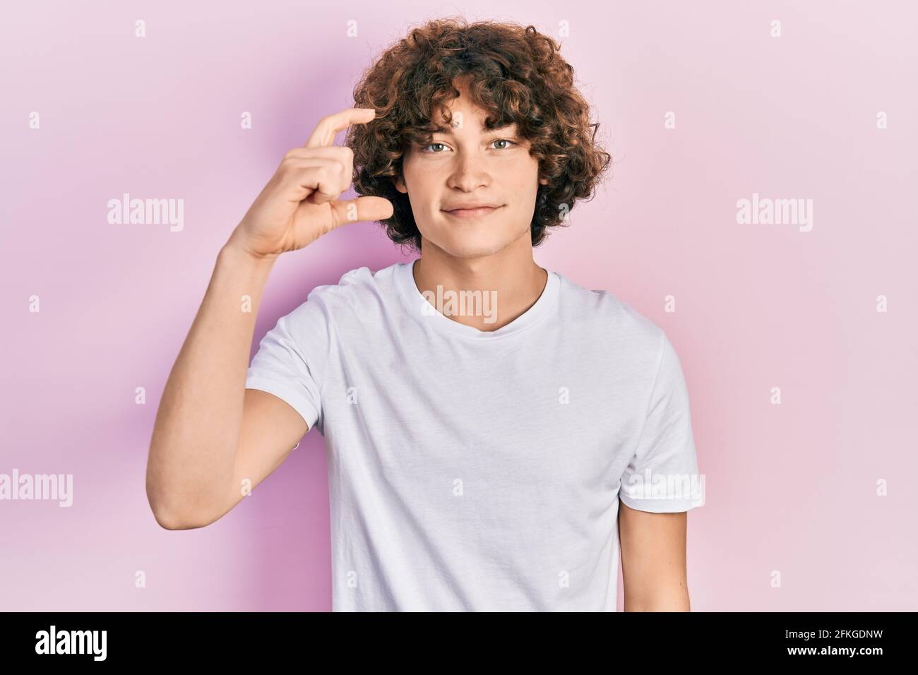 Handsome young man wearing casual white t shirt smiling and confident ...