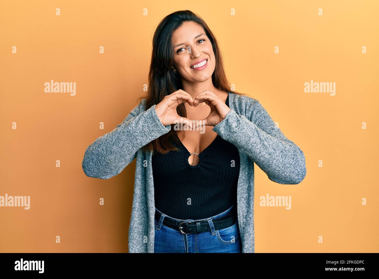 Beautiful hispanic woman wearing casual clothes smiling in love doing ...