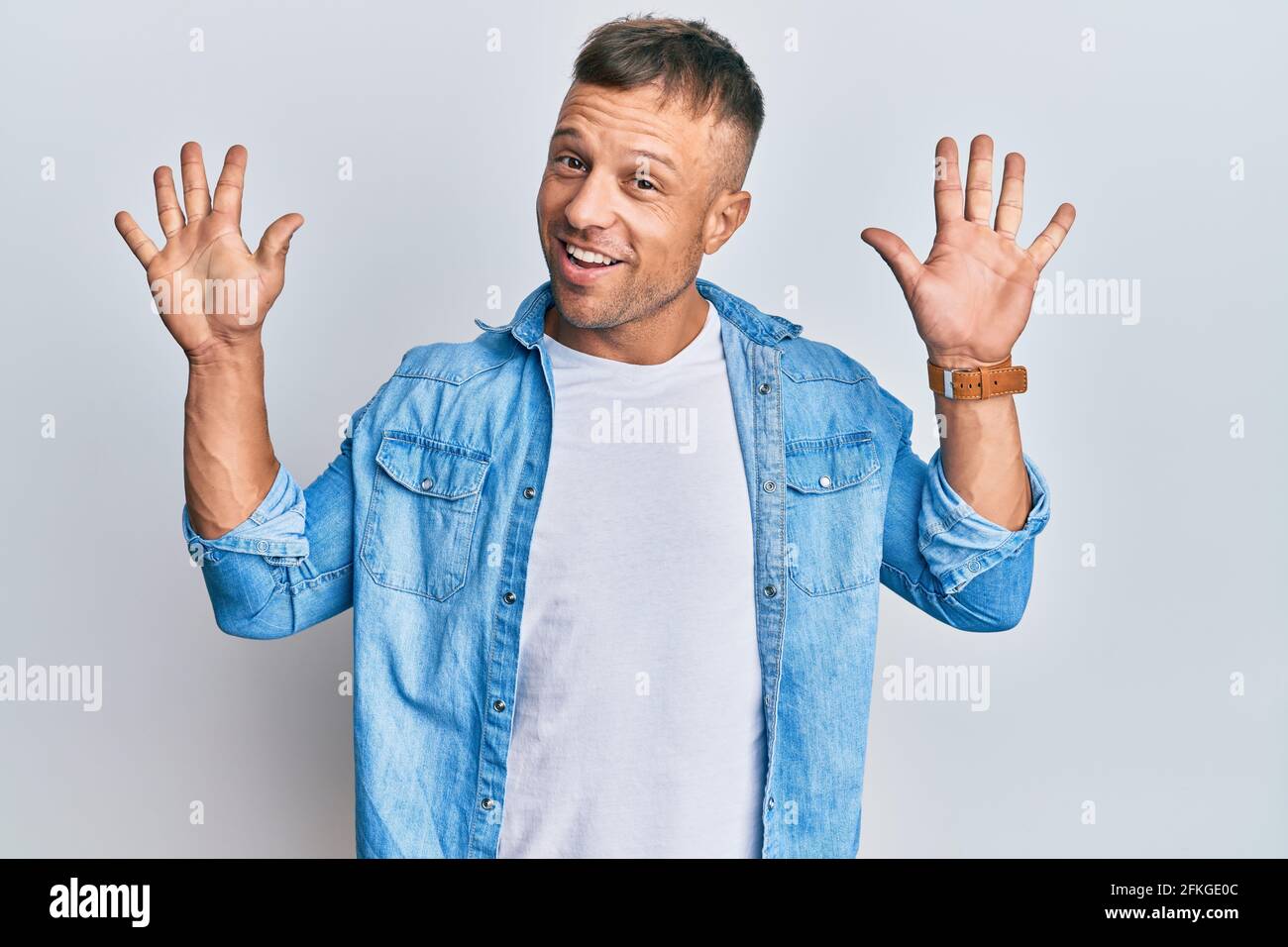 Handsome muscle man wearing casual denim jacket showing and pointing up ...