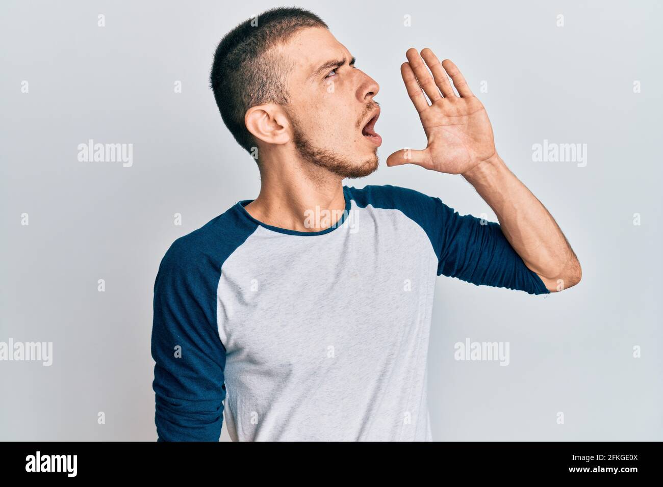 Hispanic young man wearing casual clothes shouting and screaming loud ...