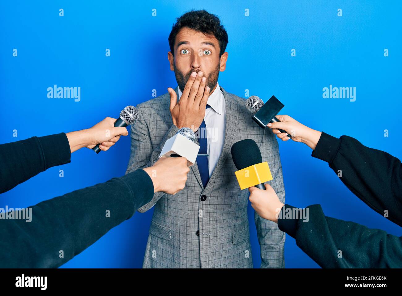 Handsome man business with beard being interviewed by reporters holding ...