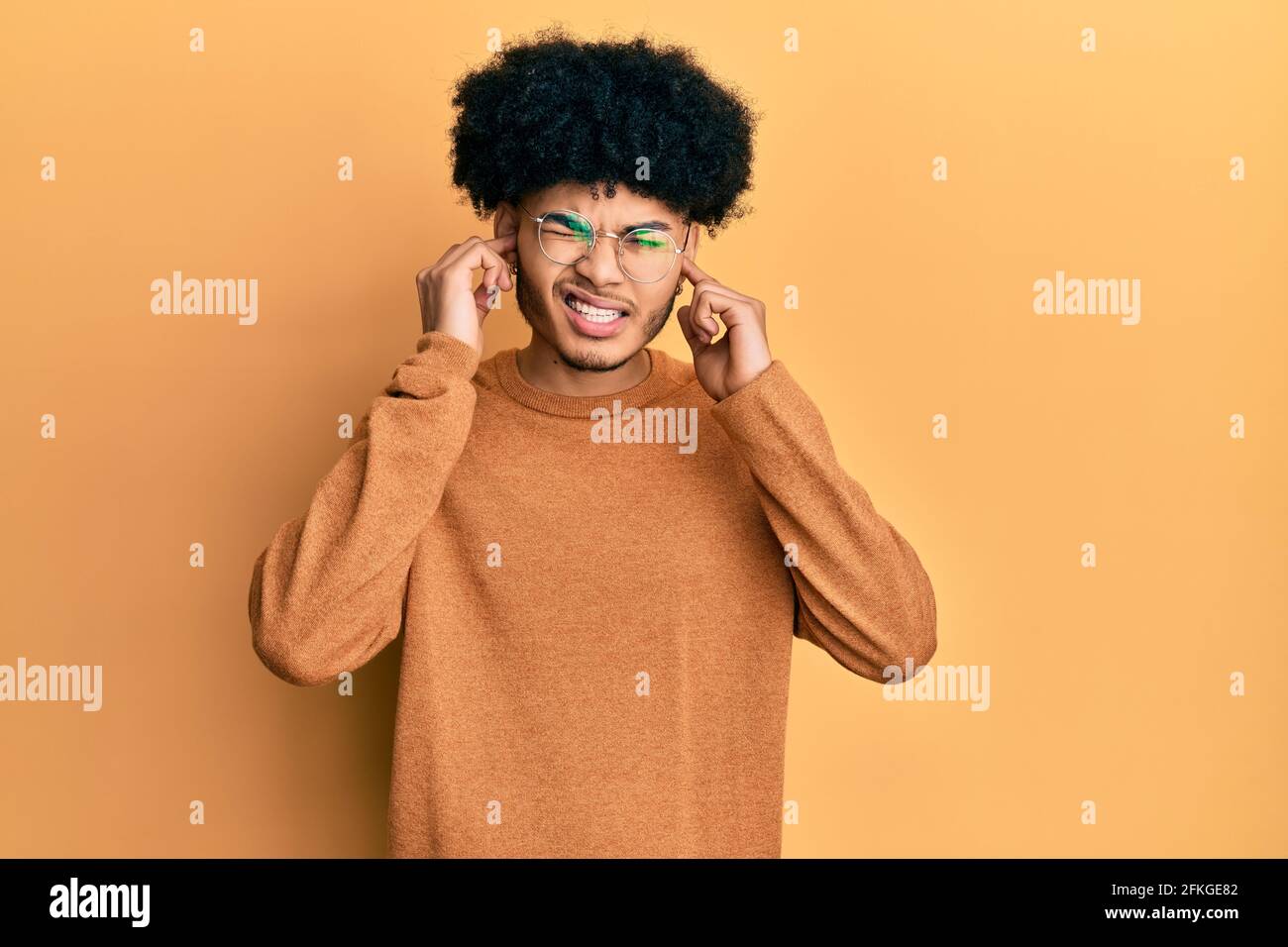 Young african american man with afro hair wearing casual winter sweater ...