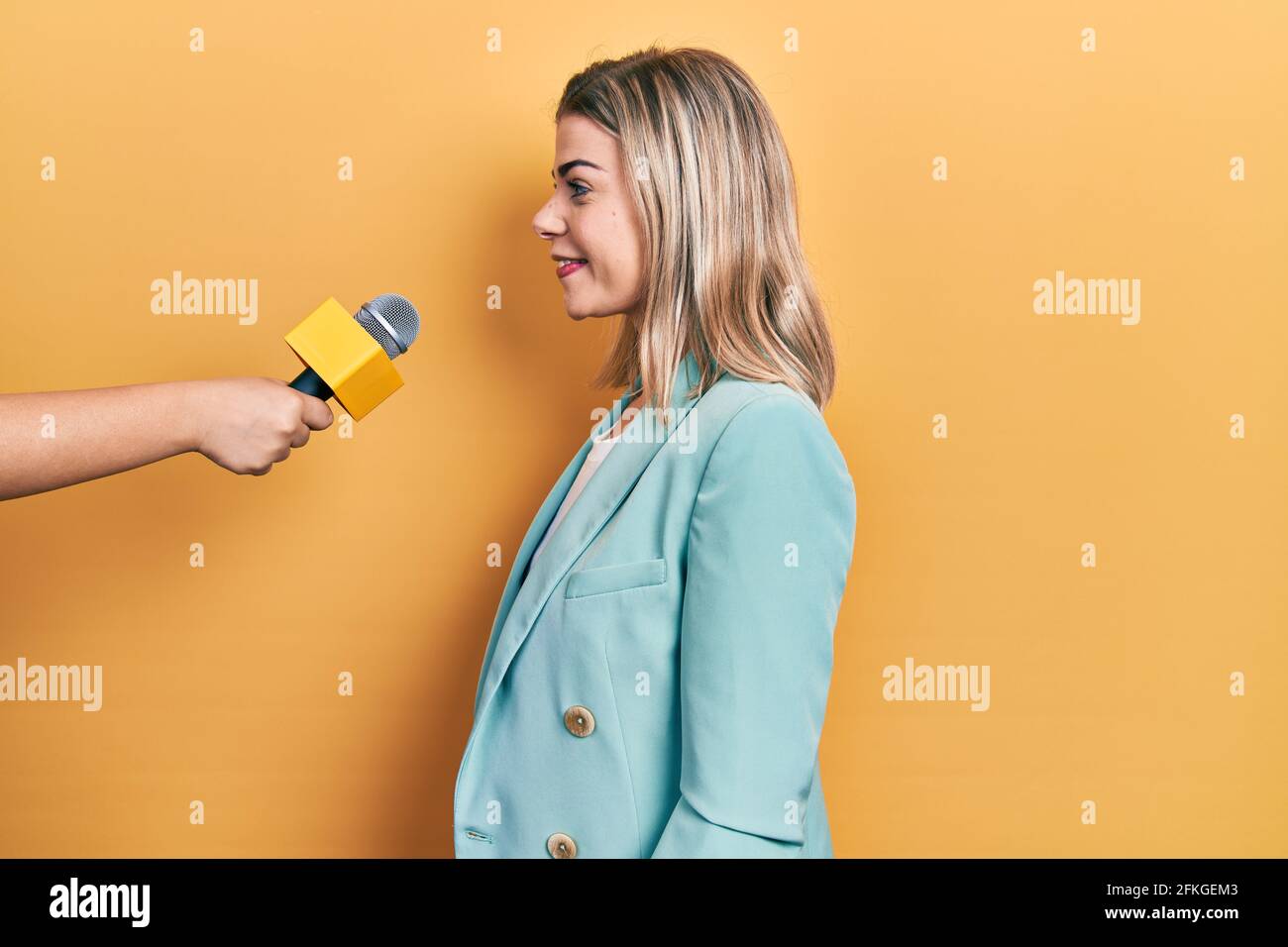 Beautiful caucasian woman being interviewed by reporter holding ...