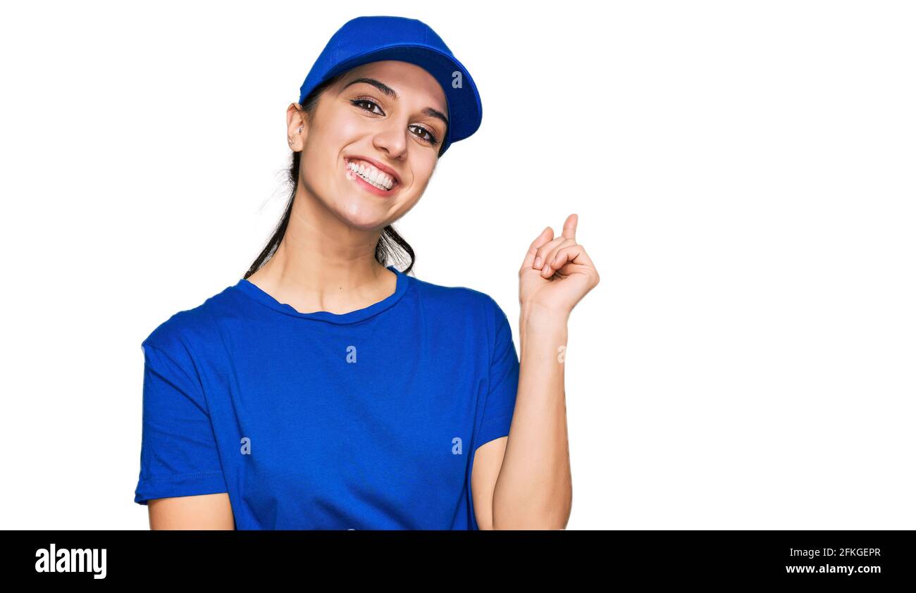 Young hispanic girl wearing delivery courier uniform with a big smile ...